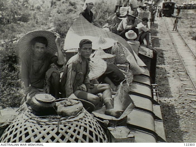 Wampo, Thailand. 19 October 1945. Asian natives sitting on the roof of ...