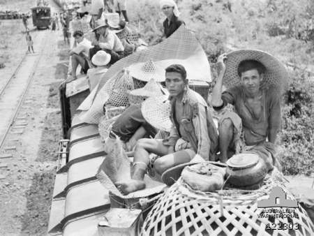 Wampo, Thailand. 19 October 1945. Asian natives sitting on the roof of ...