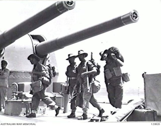 GARDEN ISLAND, SYDNEY, NSW 1945-11-30. LONG SERVICE PERSONNEL CARRYING ...