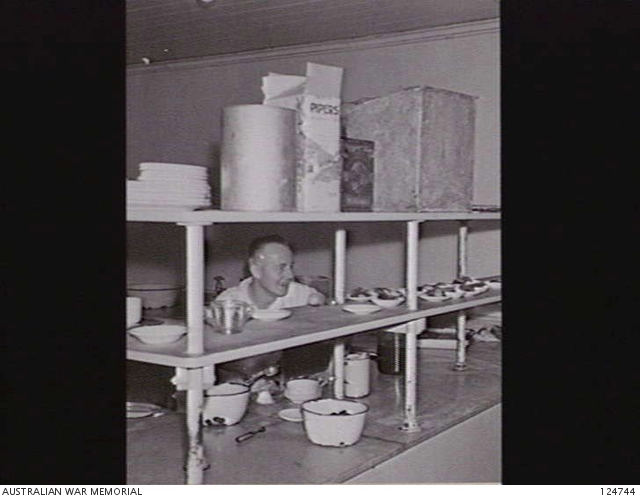 MELBOURNE, VIC 1945-12-07. A KITCHEN HAND PREPARING DESSERTS IN THE ...