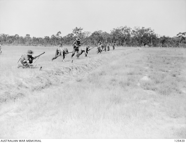 LIVERPOOL, NSW. 1945. A TEAM APPROACHING THE MOUND AT THE DOUBLE DURING ...