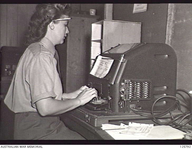 SYDNEY, NSW. 1946-15-02. NF452655 SIGNALWOMAN M. HOLLAND OPERATING A TELETYPE MACHINE IN THE ...