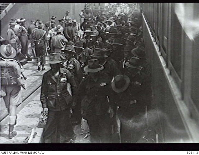 BALMAIN, NSW. 1946-03-02. JAPANESE PRISONERS DOCILELY WAITING TO BE ...