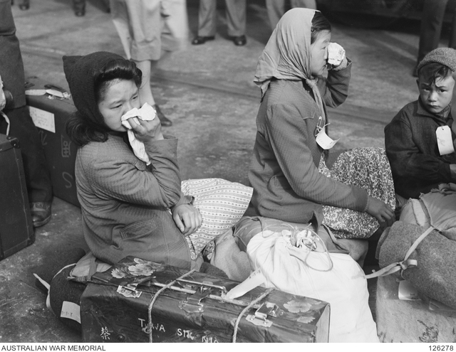 SYDNEY, NSW. 1946-03-06. TWO FORMOSAN GIRLS SIT ON THEIR LUGGAGE CRYING ...