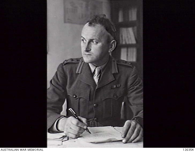 MELBOURNE, VIC. 1946-03-13. COLONEL A. MILNER, AT HIS DESK AT VICTORIA ...
