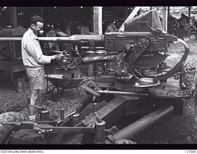 BANYO, QLD. 1946-05-17. A MEMBER OF 7TH BASE ORDNANCE DEPOT TREATING ...