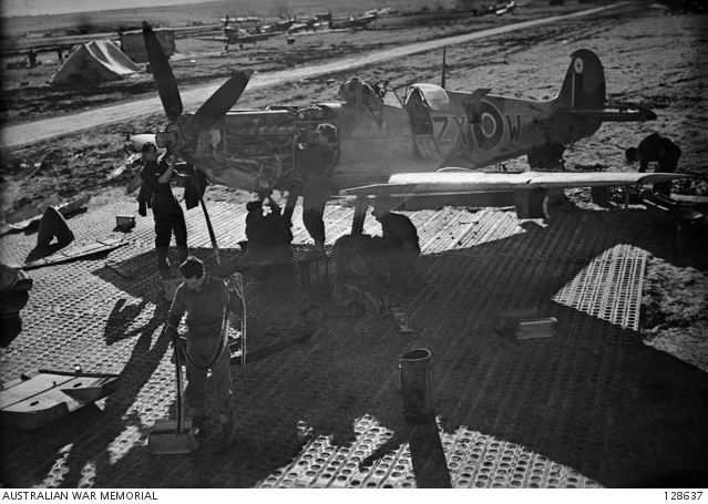 ITALY. 1944-02. A RAF SPITFIRE AIRCRAFT BEING SERVICED AT A FORWARD ...