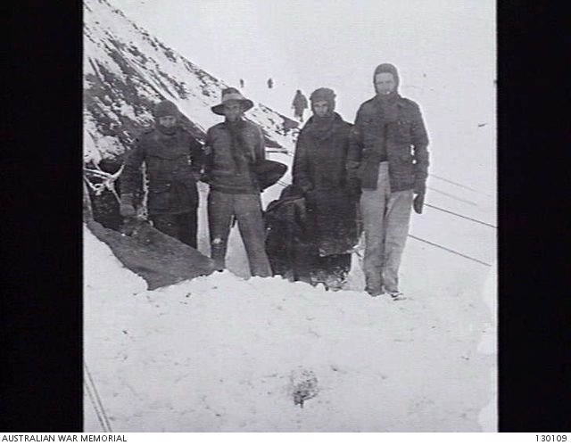 Troops outside their snow covered tents at Christmas. From left to ...