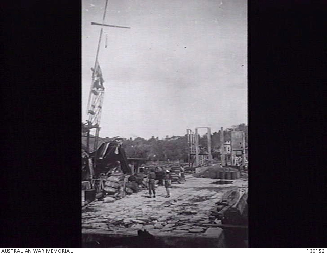 An Australian flag being hoisted on board HMAS Deloraine berthed at the ...