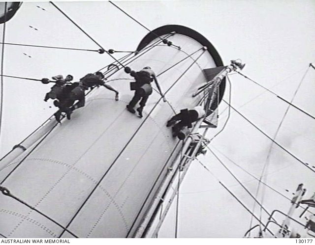 Sailors painting the “after” funnel on board HMAS Shropshire, carrying ...