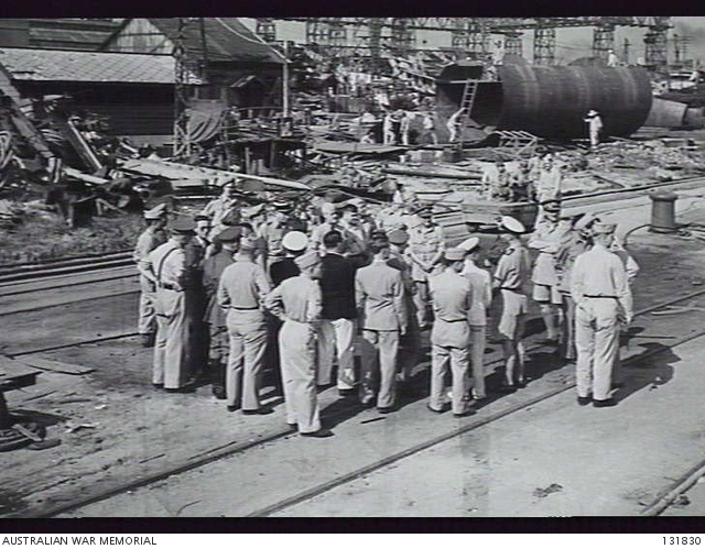 KURE, JAPAN. 1946-09-10. PARTY INSPECTING BOMB DAMAGED SHIPYARD ...