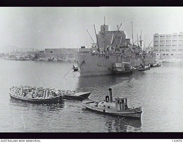PIRAEUS, GREECE. 1945-07. A GREEK TUG BOAT PULLING BARGES LOADED WITH ...