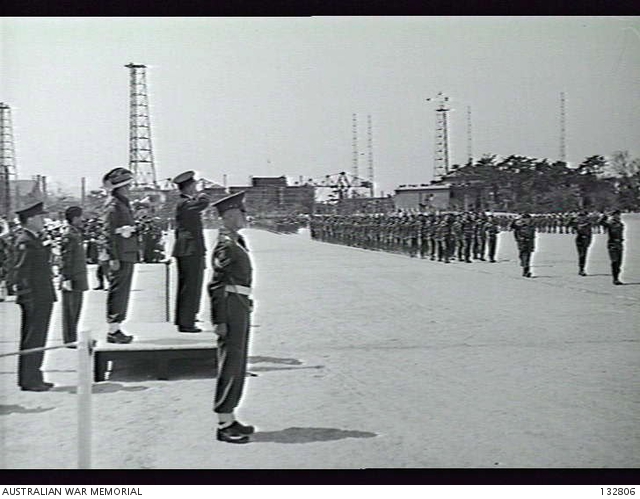 KURE, JAPAN. 1947-04-25. THE 980 IWT COMPANY MARCH PAST THE SALUTING ...