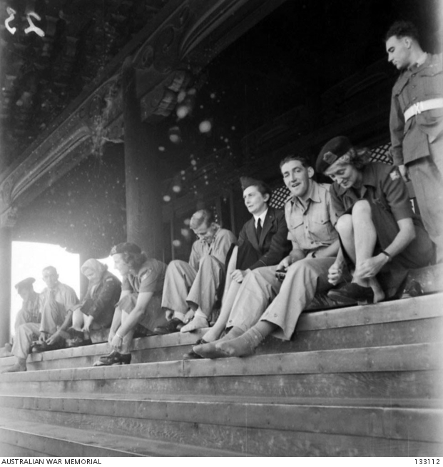 KYOTO, JAPAN. 1947-08. MEMBERS OF BCOF SITTING ON THE STEPS OF THE ...