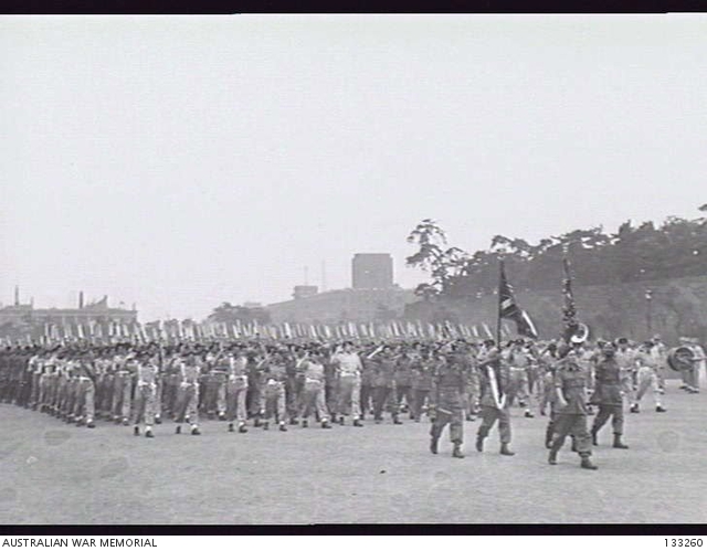 TOKYO, JAPAN. 1947-07-4. TROOPS FROM BCOF PASS THE SALUTING BASE DURING ...