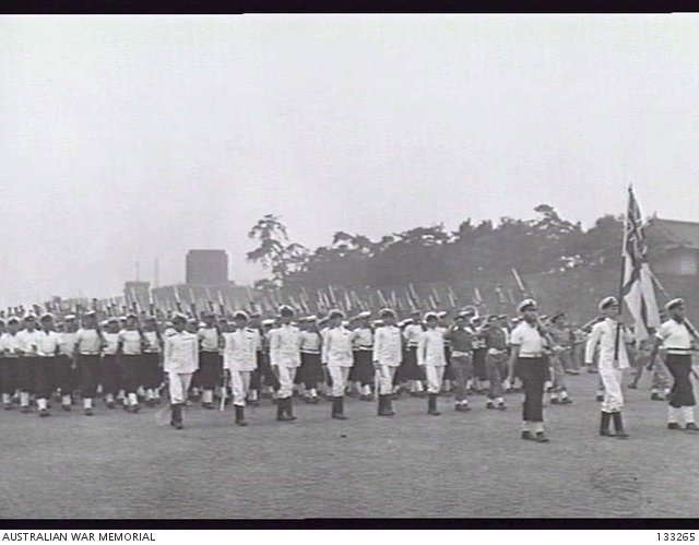 TOKYO, JAPAN. 1947-07-4. TROOPS FROM BCOF PASS THE SALUTING BASE DURING ...