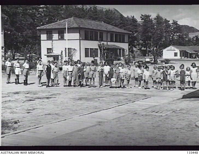 ETA JIMA, JAPAN. 1947-09-15. CHILDREN LINED UP READY TO GO INTO SCHOOL ...