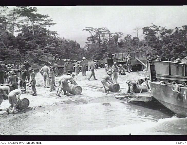LAE, NEW GUINEA. 1943-10-02. LOADING SUPPLIES ON TO LANDING CRAFT ...