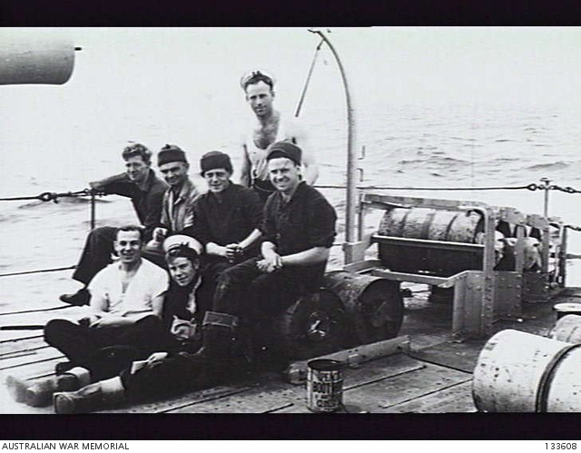 1940. DEPTH CHARGE PARTY SITTING ON THE DECK OF THE DESTROYER HMAS ...