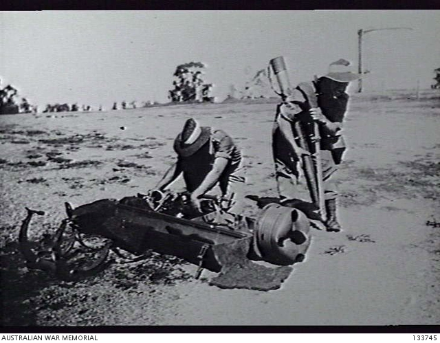 DURING MORTAR CONTAINER DRILL, NO 1 MEMBER OF A MORTAR DETACHMENT MOVES ...