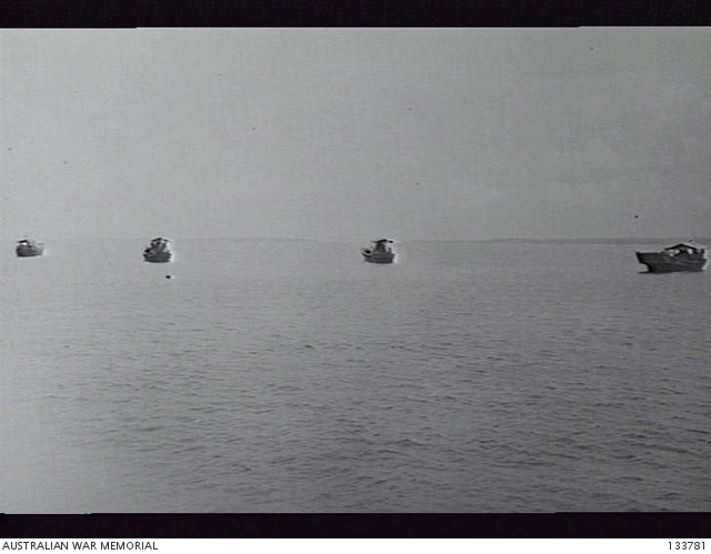 SORONG, DUTCH NEW GUINEA. 1945. JAPANESE BARGES OFF HMAS LACHLAN DURING ...