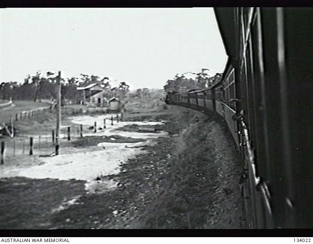 QLD. 1944-12. A TROOP TRAIN TRAVELLING NORTH TO THE ATHERTON TABLELAND ...