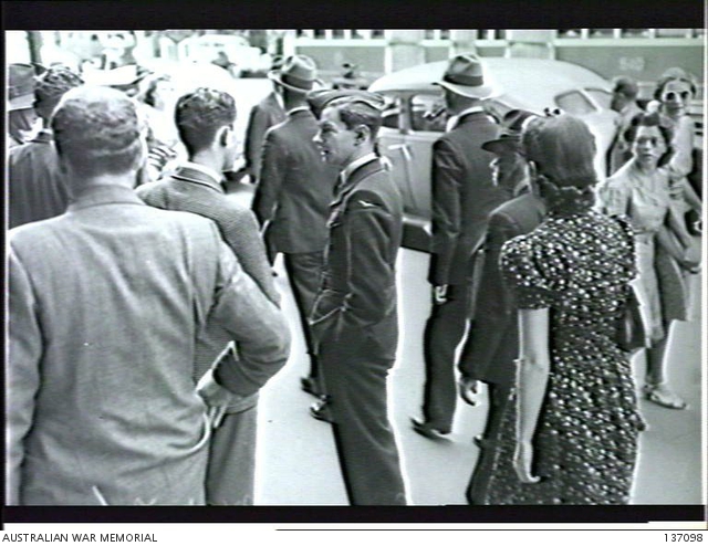 MELBOURNE, VIC. 1942-11-12. SERVICEMEN AND CIVILIANS MOVE ALONG A CITY ...