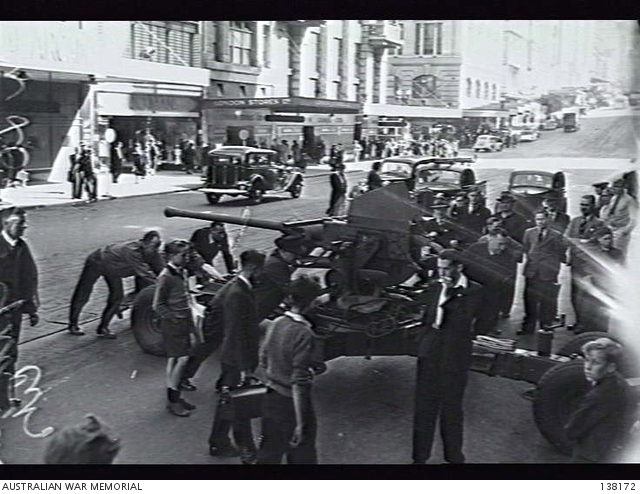 MELBOURNE, VIC. 1943-03-18. WORKMEN MANOEUVRING A 40 MM BOFORS GUN INTO ...