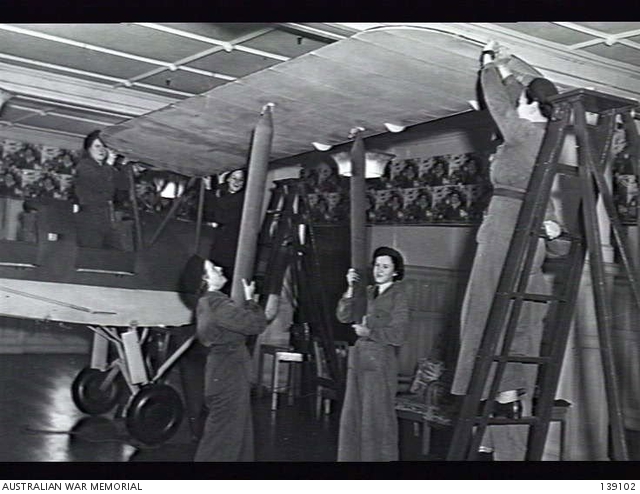 Melbourne, Vic. 1943-06-16. A RAAF Corporal rigger assisted by Women's ...