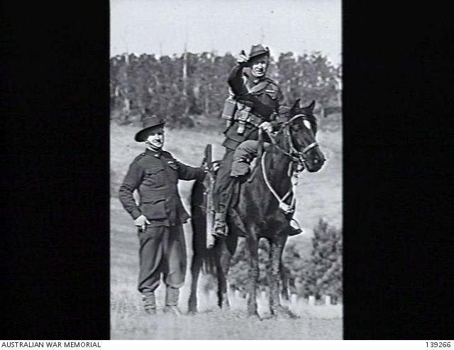 Merboo, Vic. 1943-07-07. Sergeant Bert Drake indicates an area to be ...