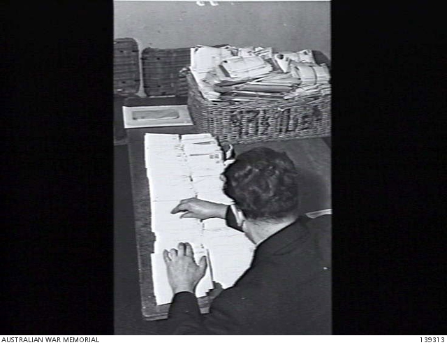 MELBOURNE, VIC. 1943-07-14. AN AUSTRALIAN LETTER CENSOR, STACKING ...
