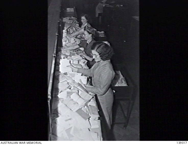 MELBOURNE, VIC. 1943-07-14. WOMEN POSTAL EMPLOYEES SORTING MAIL FOR ...