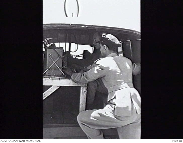 VICTORIA. 1944-02-22. AN OFFICER OF THE RAAF DICTATING MESSAGES TO BE ...