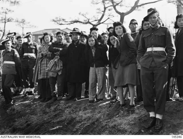 Kure, Japan. 1948-02-20. Japanese civilians and Australian troops watch ...