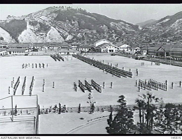 Hiro, Japan. 1948-06-12. Elevated view of BCOF troops presenting arms ...