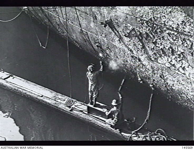 Kure, Japan. 1948-07-01. Japanese labourers welding up holes to refloat ...