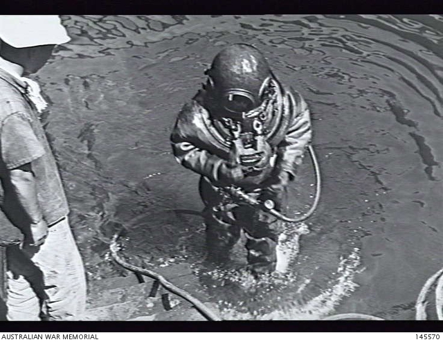 Kure, Japan. 1948-07-01. A Japanese diver dressed in his diving suit ...