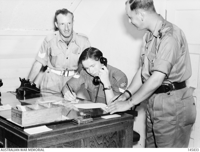 Kure, Japan. 1948-09-08. Officers checking dockets used for trunkline ...