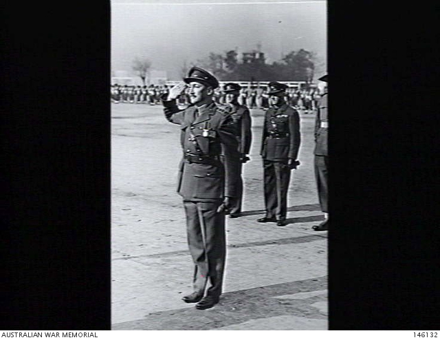 Kure, Japan. 1949-01-26. Captain King, Signals, BCOF, salutes after ...
