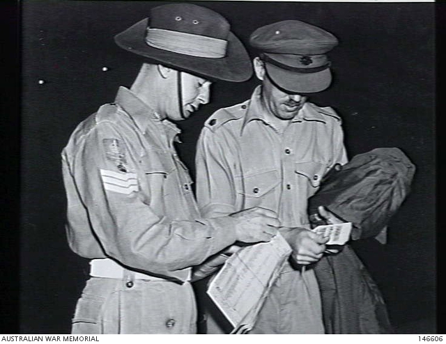 Hiro, Japan. 1950-08-30. Major Gordon, in charge of the draft, handing ...