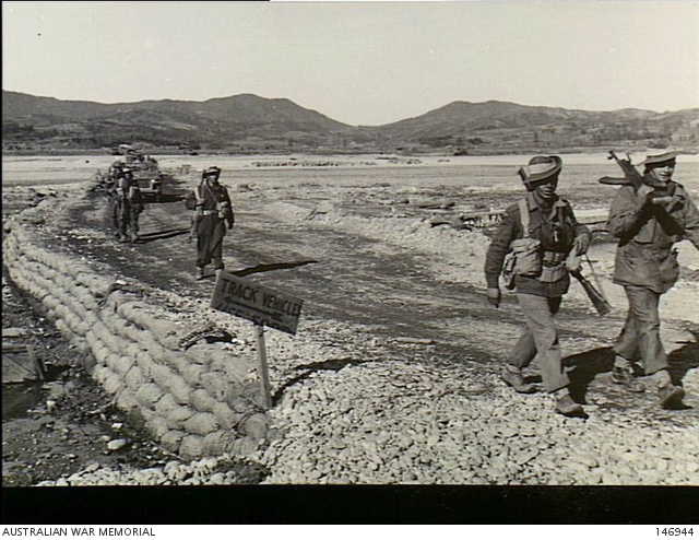 Pakchon, Korea. 1950-11-04. Troops file over a river crossing during ...