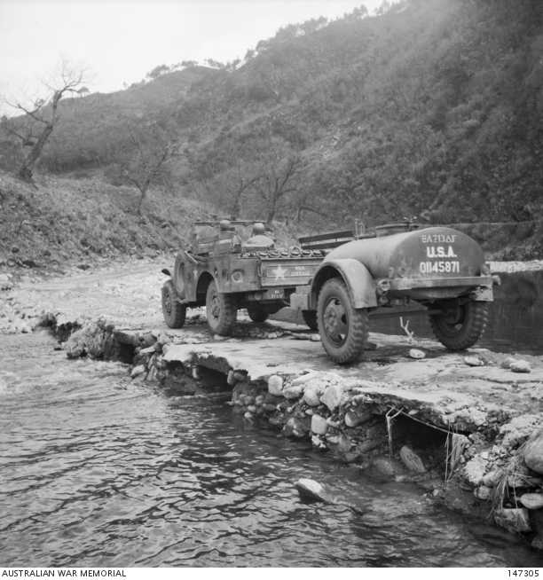 38th Parallel, Korea. 1951-04-09. An American jeep towing a small ...