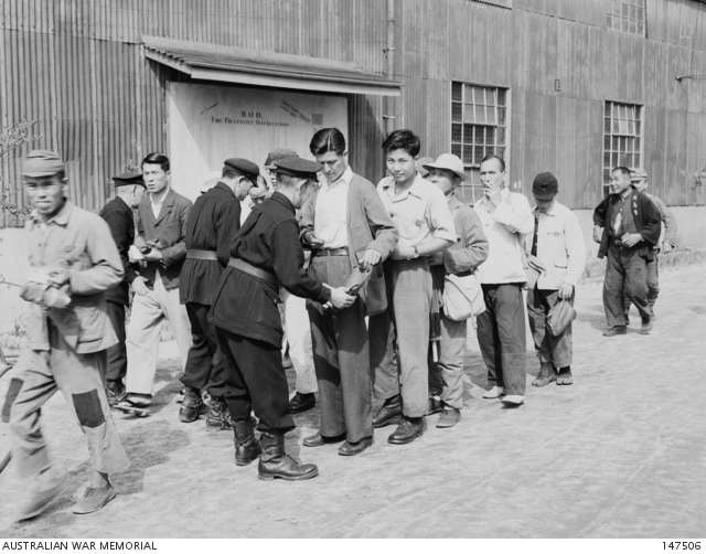 Kure, Japan. 1951. Japanese workers being searched at the main gate at ...