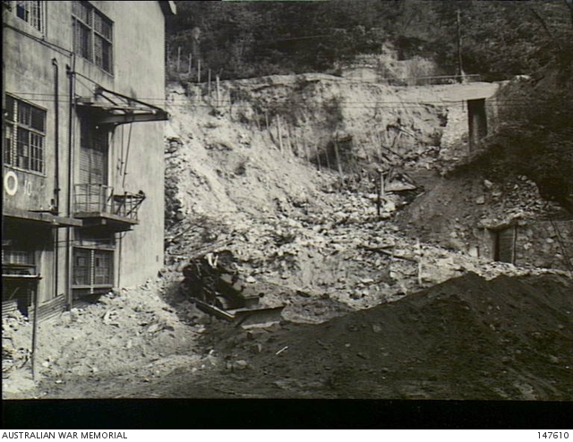Kure-Hiro Area, Japan. 1951-10-14. A grader tries to clear away debris ...
