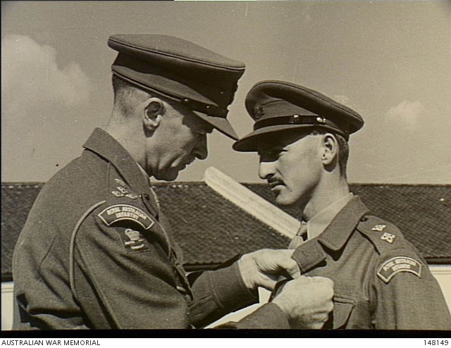 Hiro, Japan. 1952-10-28. Brigadier I. R. Campbell (left) pinning the MC ...