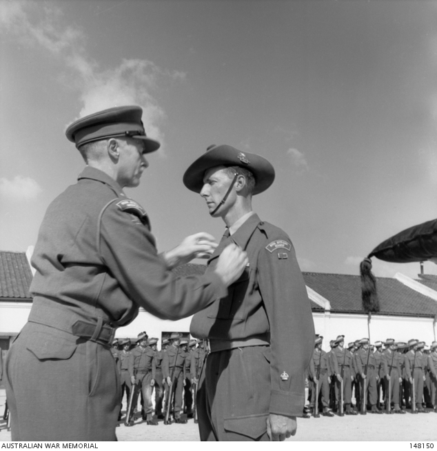 Hiro, Japan. 1952-10-28. Brigadier I. R. Campbell (left) pinning the ...