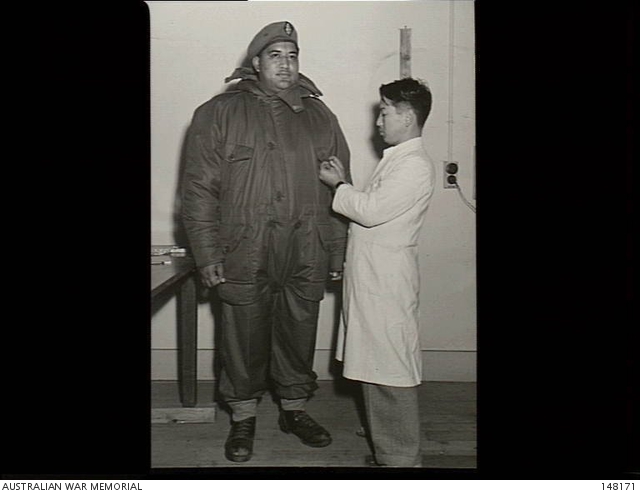 Kure, Japan. 1952-11-05. Chief tailor making adjustments at the British ...