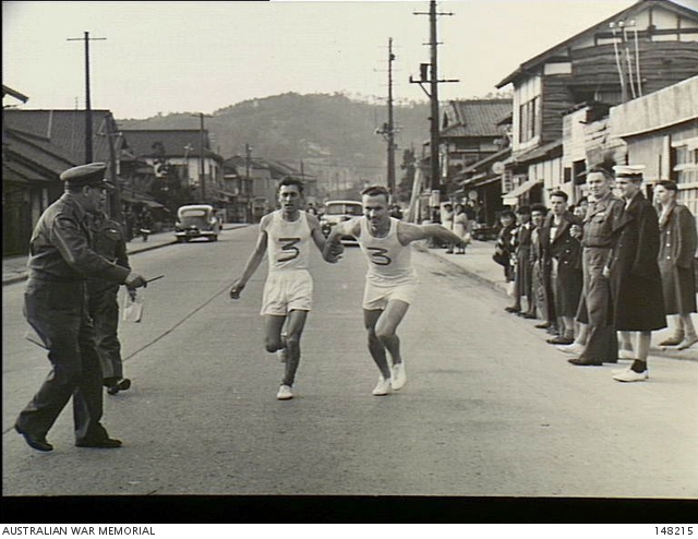 Hiroshima, Japan. 1952-11-19. Sergeant E. J. Belcher (left) handing ...