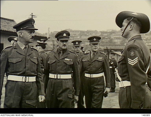 Kure, Japan. 1953-03-24. Brigadier R. H. Maxwell CB, who is accompanied ...