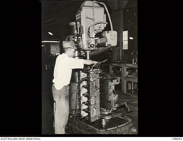 Kure, Japan. 1953-09. A Japanese civilian employee operating a honing ...
